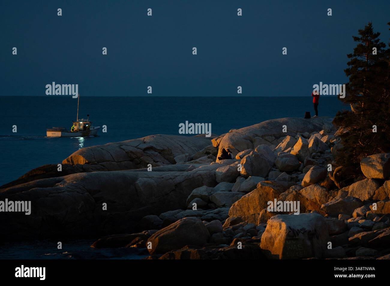 A person watches a partial solar eclipse at Herring Cove Provincial ...