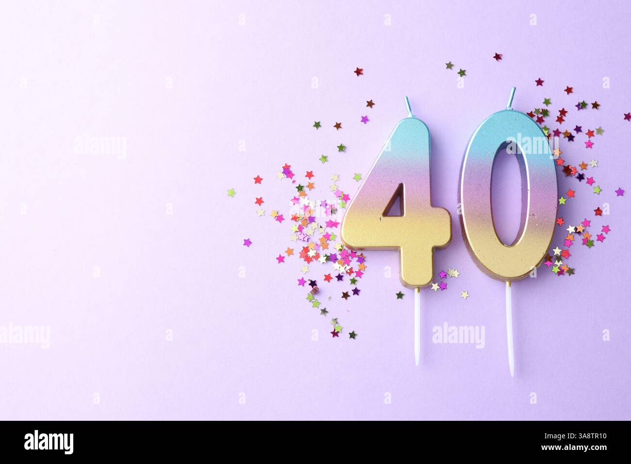 40th birthday. Number shaped candles and confetti on violet background ...
