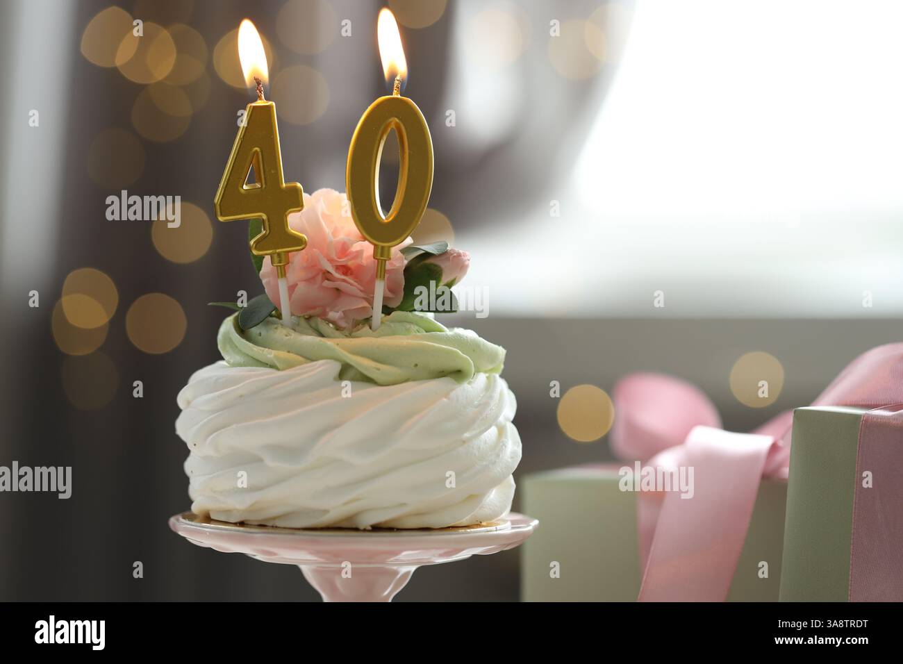 40th birthday. Tasty cupcake with burning number shaped candles and ...