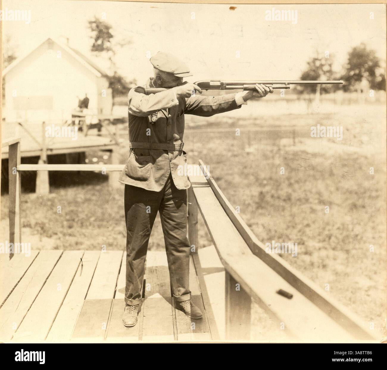 This image captures a trapshooting event, focusing on a shooter taking ...