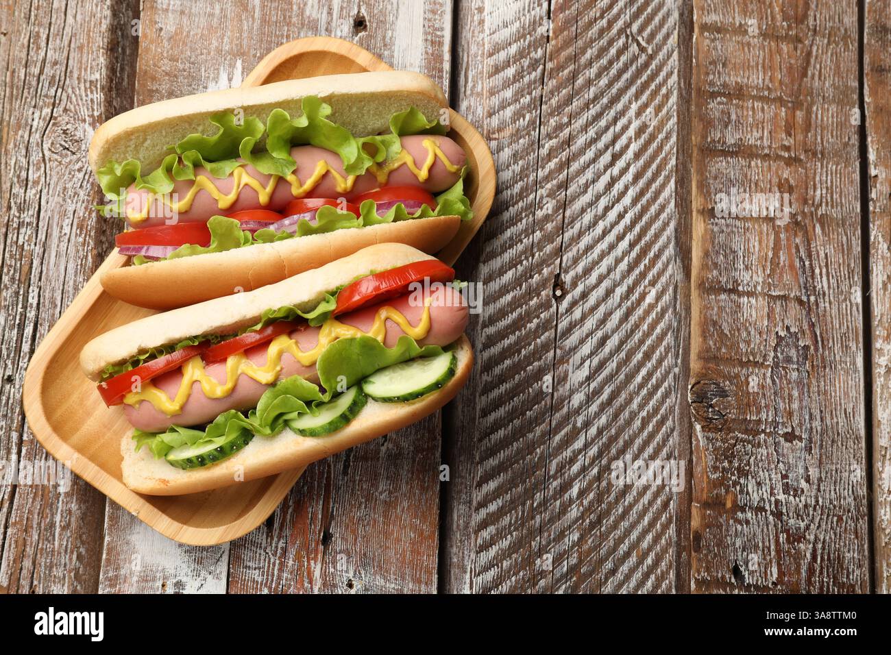 Tasty hot dogs on wooden table, top view. Space for text Stock Photo ...