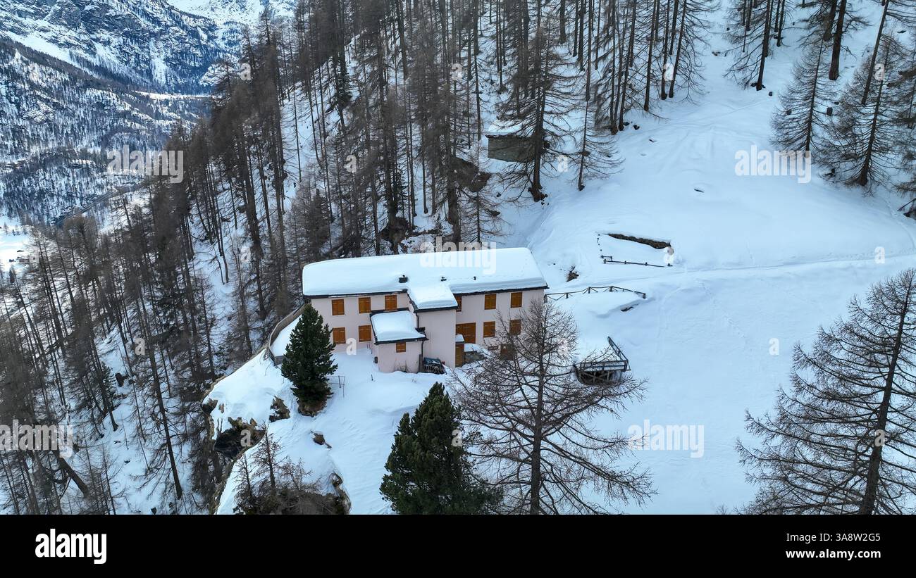 Mountain Hut Edelweiss in winter with deep snow covered roof. Located ...