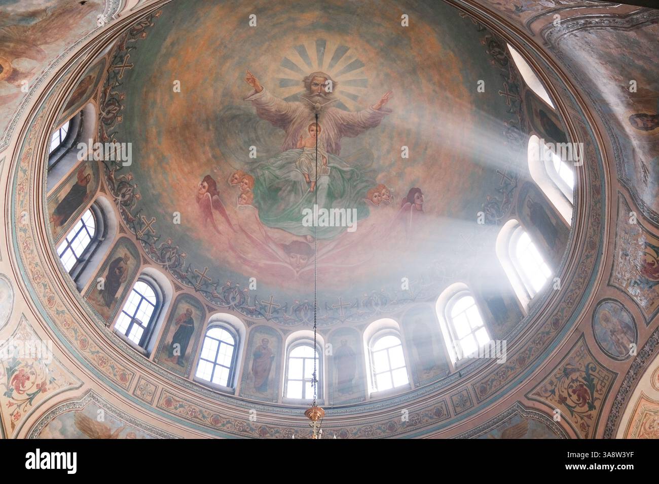 A large, round, stained glass dome with a painting of Jesus Christ on ...