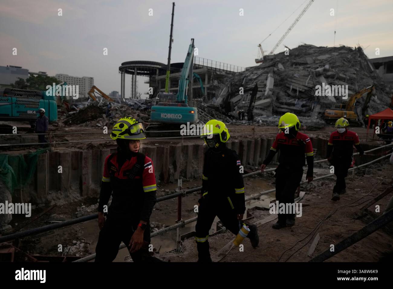 Rescuers work at the site of an under-construction high-rise building ...