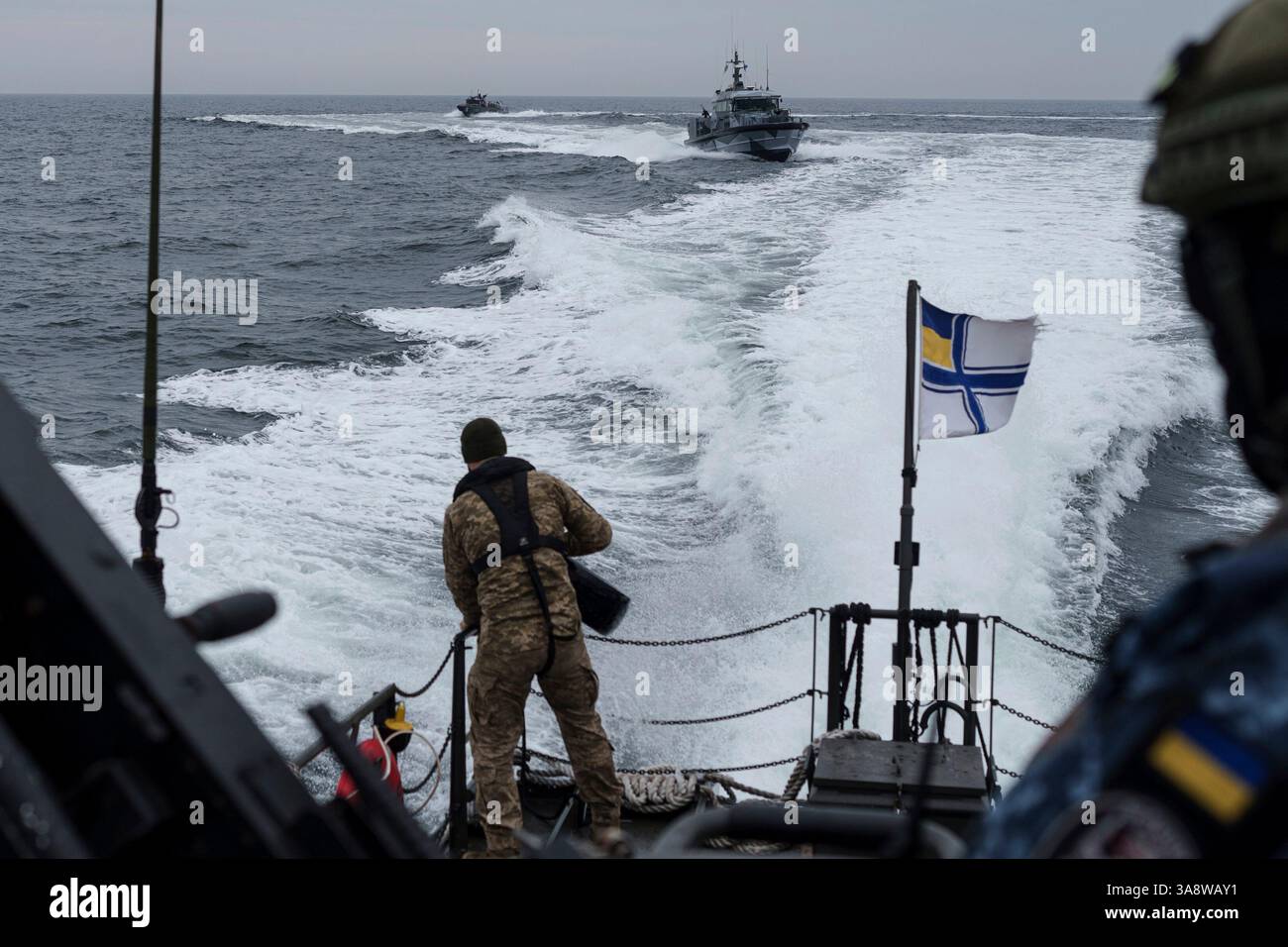A Ukrainian serviceman of Military Naval Forces stands on a boat during ...