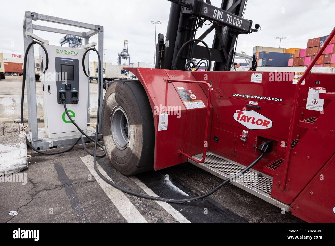 An electric top-handler is charging at a charging station at the Yusen ...