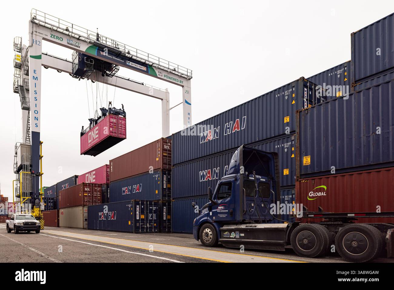 A container is lifted by an electric rubber tired gantry at the Yusen ...