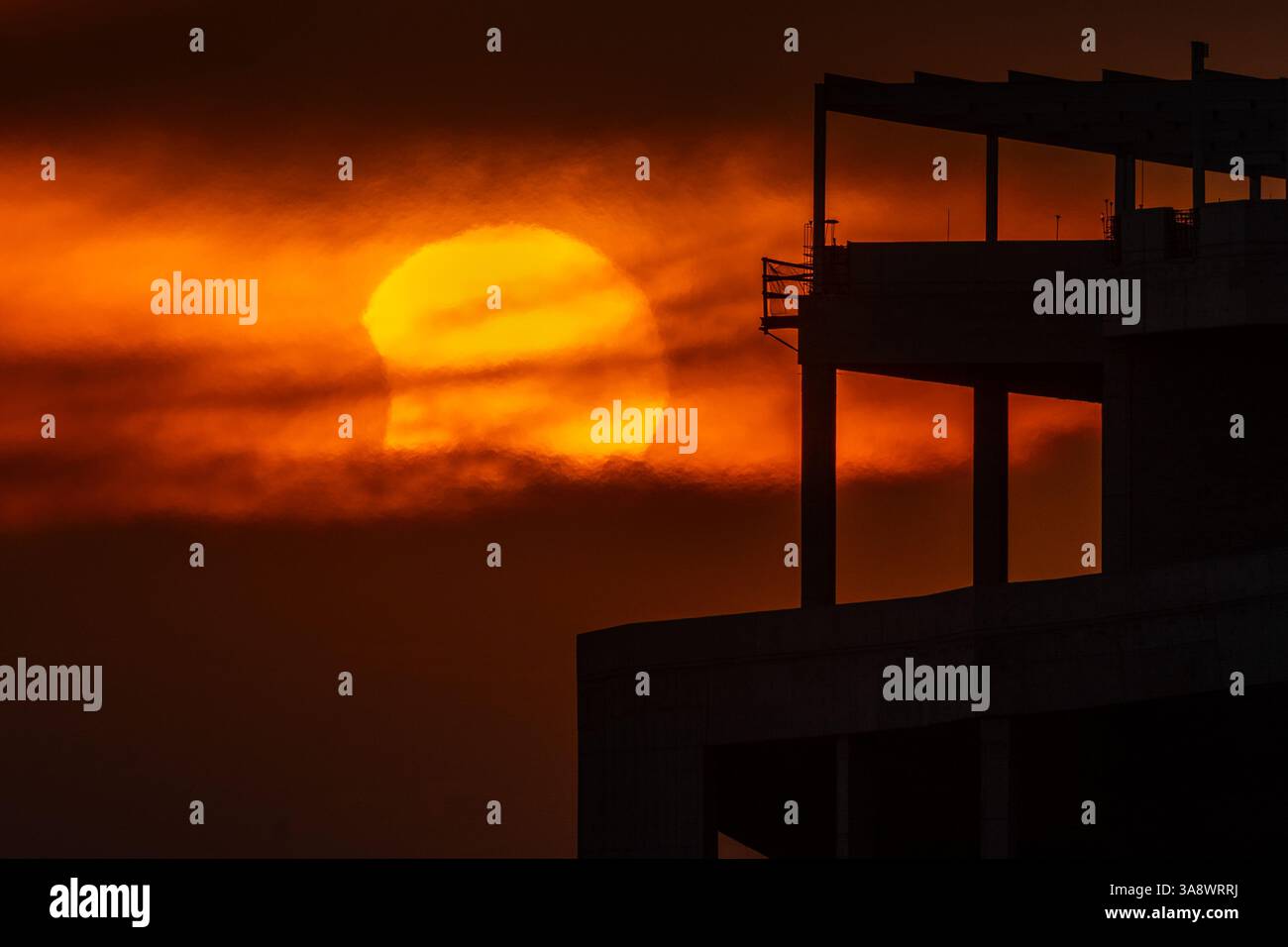 A partial solar eclipse is seen as the Sun rises over Brooklyn on March ...