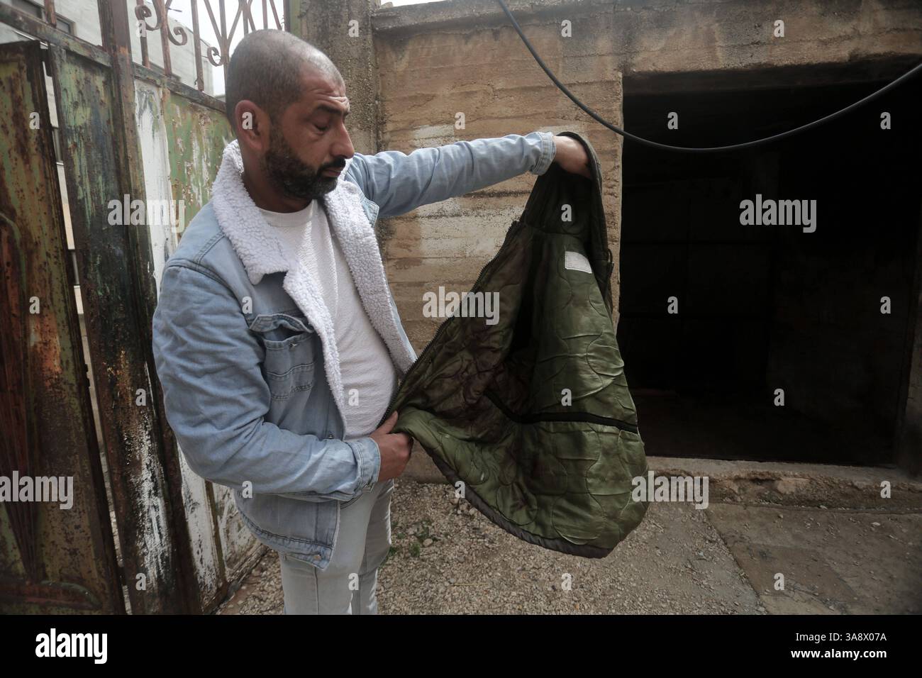 Relatives of Palestinian martyr Ahmed Bani Odeh inspect the site of the ...