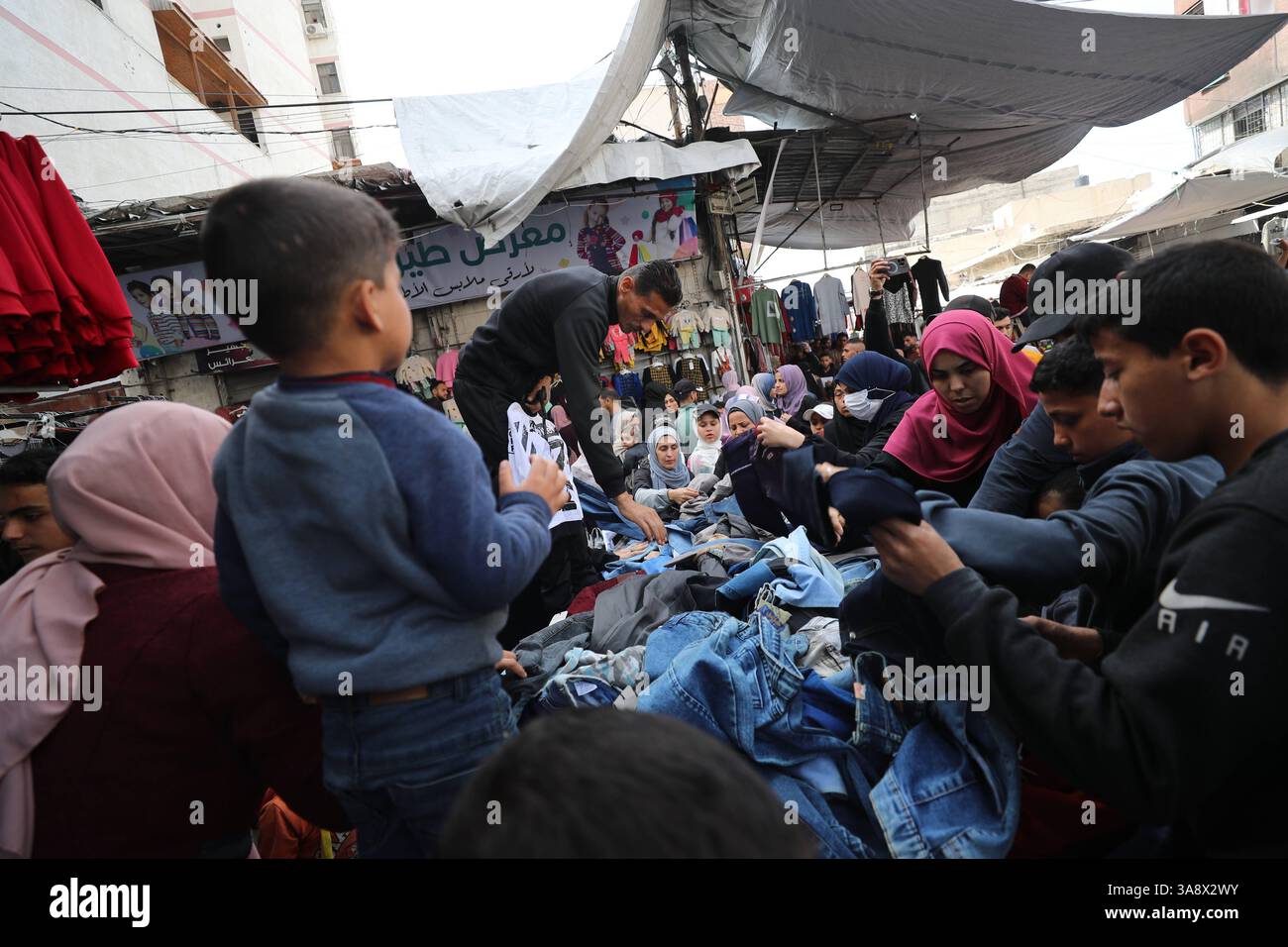 Palestinians shop at a local market in preparation for the upcoming Eid ...