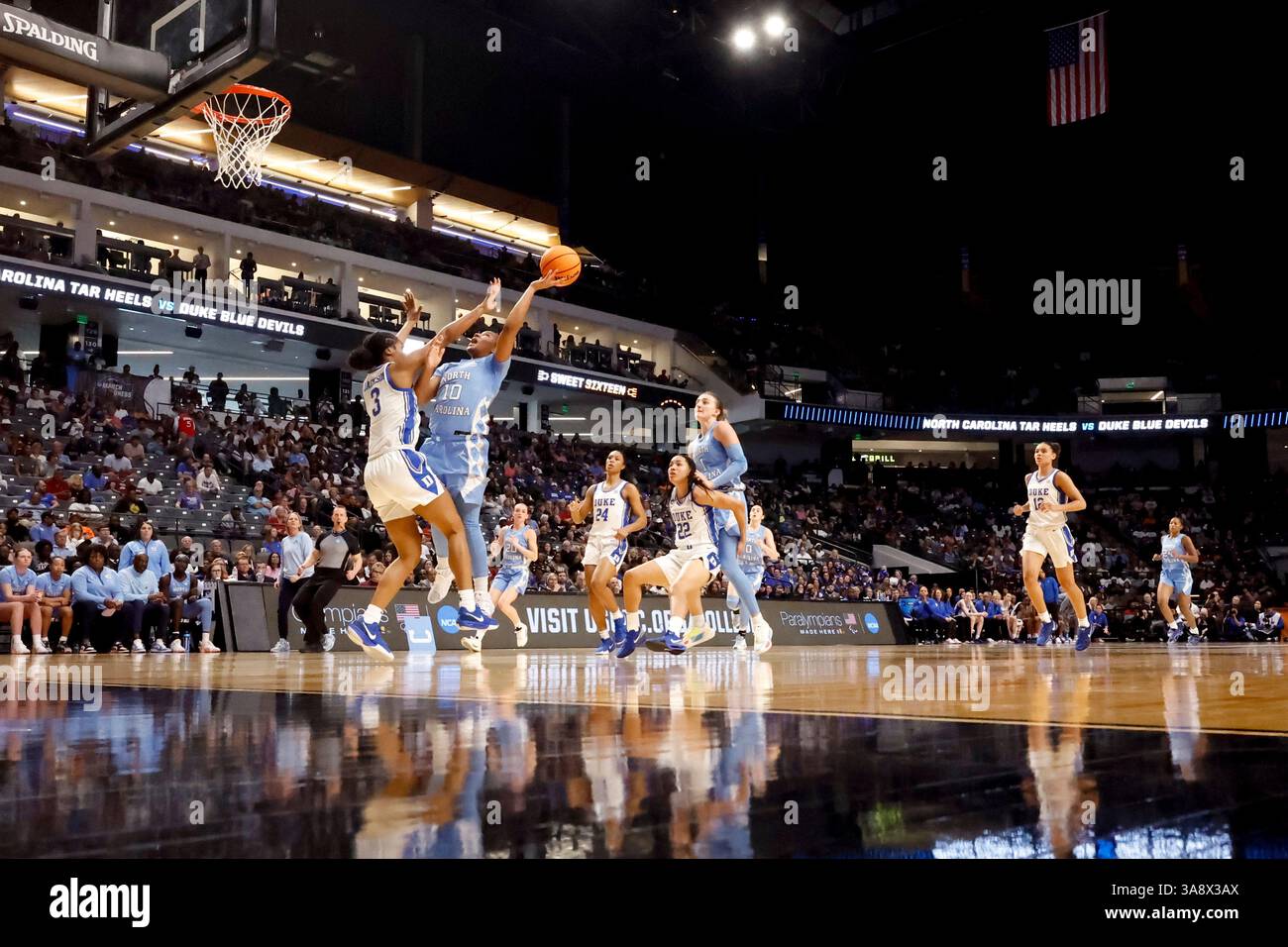 North Carolina guard Reniya Kelly (10) puts up a shot over Duke guard ...