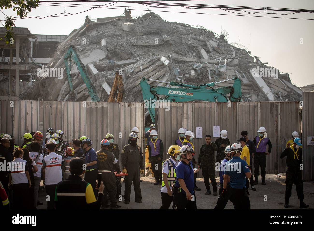Rescue teams work tirelessly amidst the rubble of a collapsed ...