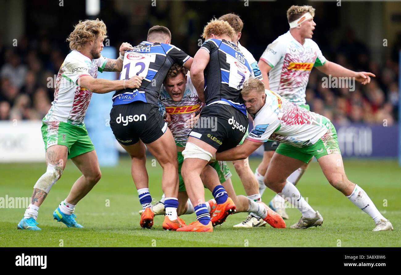 Harlequins' Oscar Beard (centre) is tackled by Bath Rugby's Cameron ...