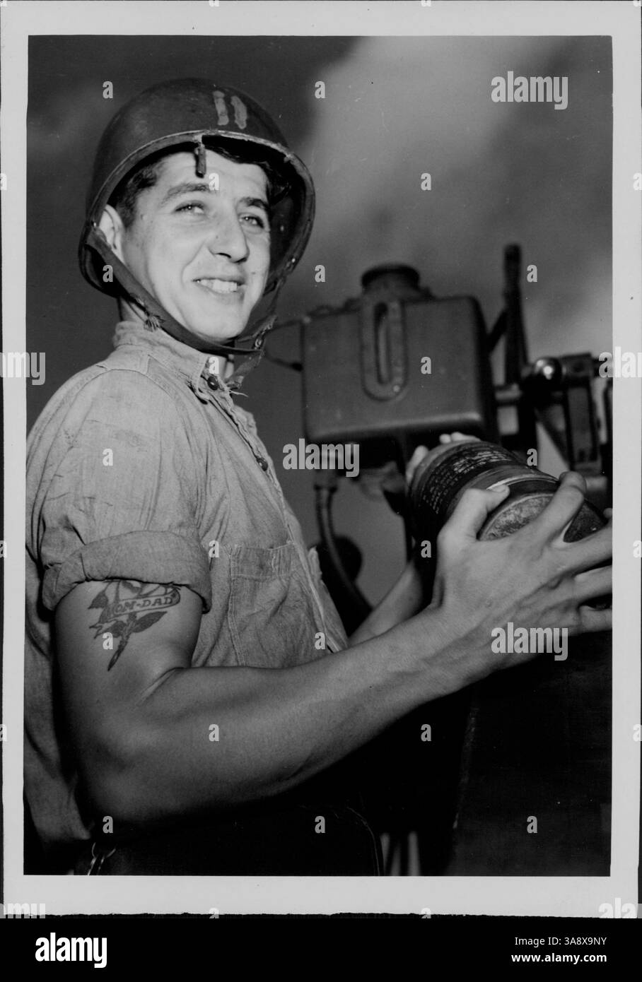 Frank Novitsky, a seaman first class, prepares to load artillery aboard ...