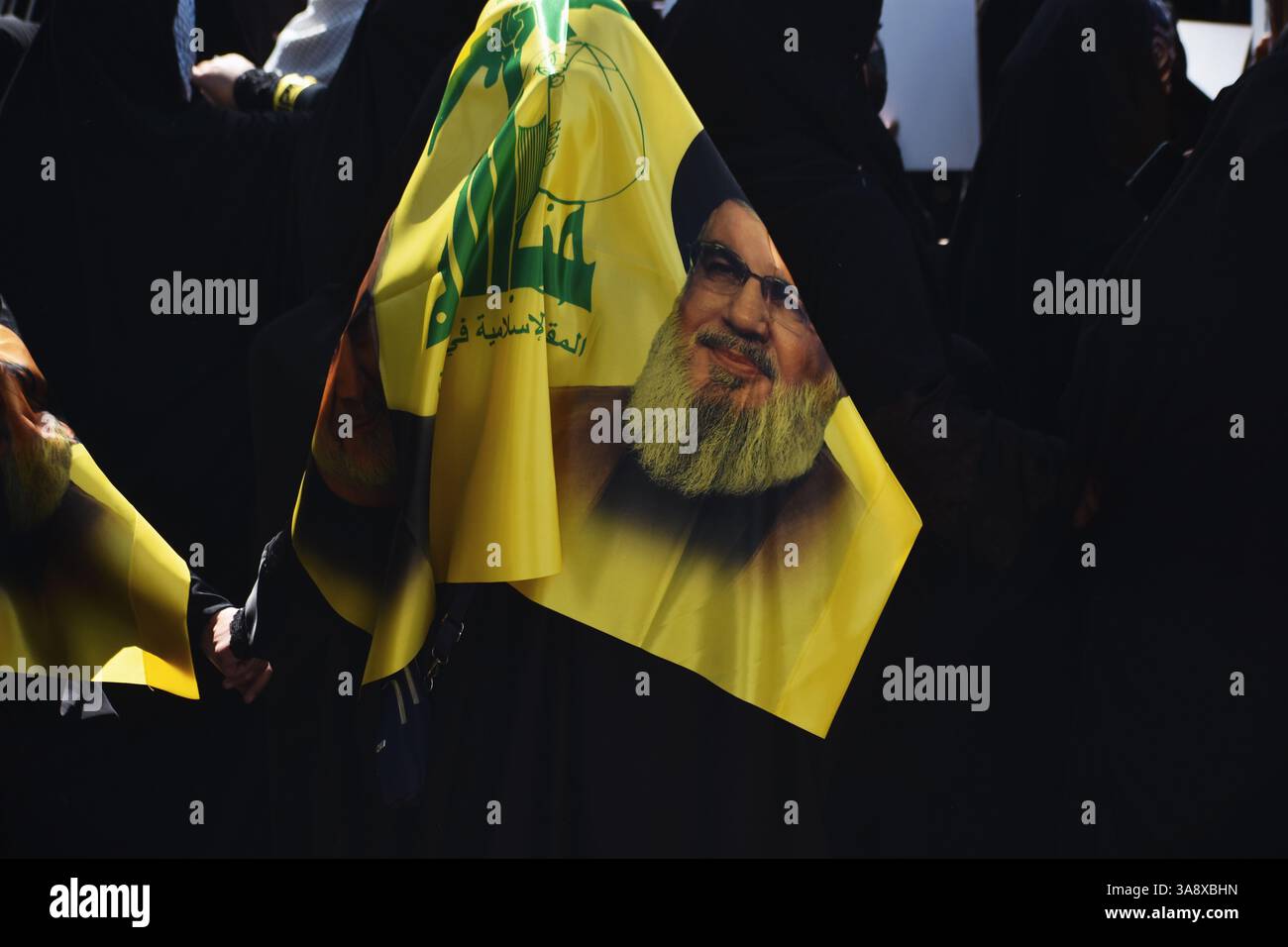 A Kashmiri girl wearing a scarf depicting portraits of slain Hezbollah ...