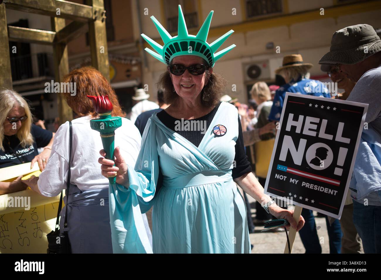 A protester dressed as The Statue of Liberty is seen posing for a photo ...
