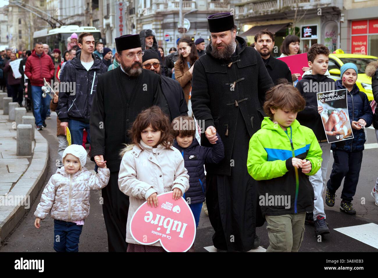 Clerics walk with children during an anti-abortion march in Bucharest ...