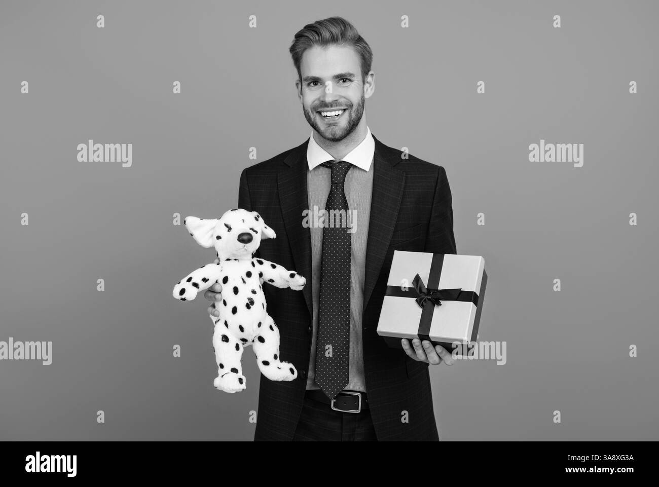 Businessman man with corporate gift box and toy at business party ...