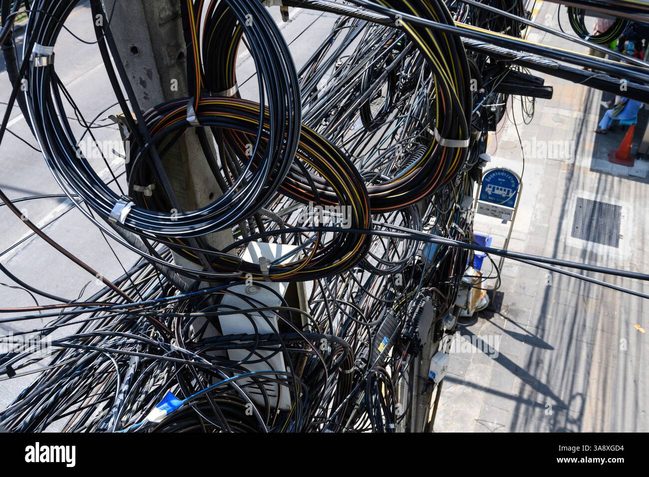 March 4, 2025, Bangkok, Thailand: A tangled mess of cables and wires ...