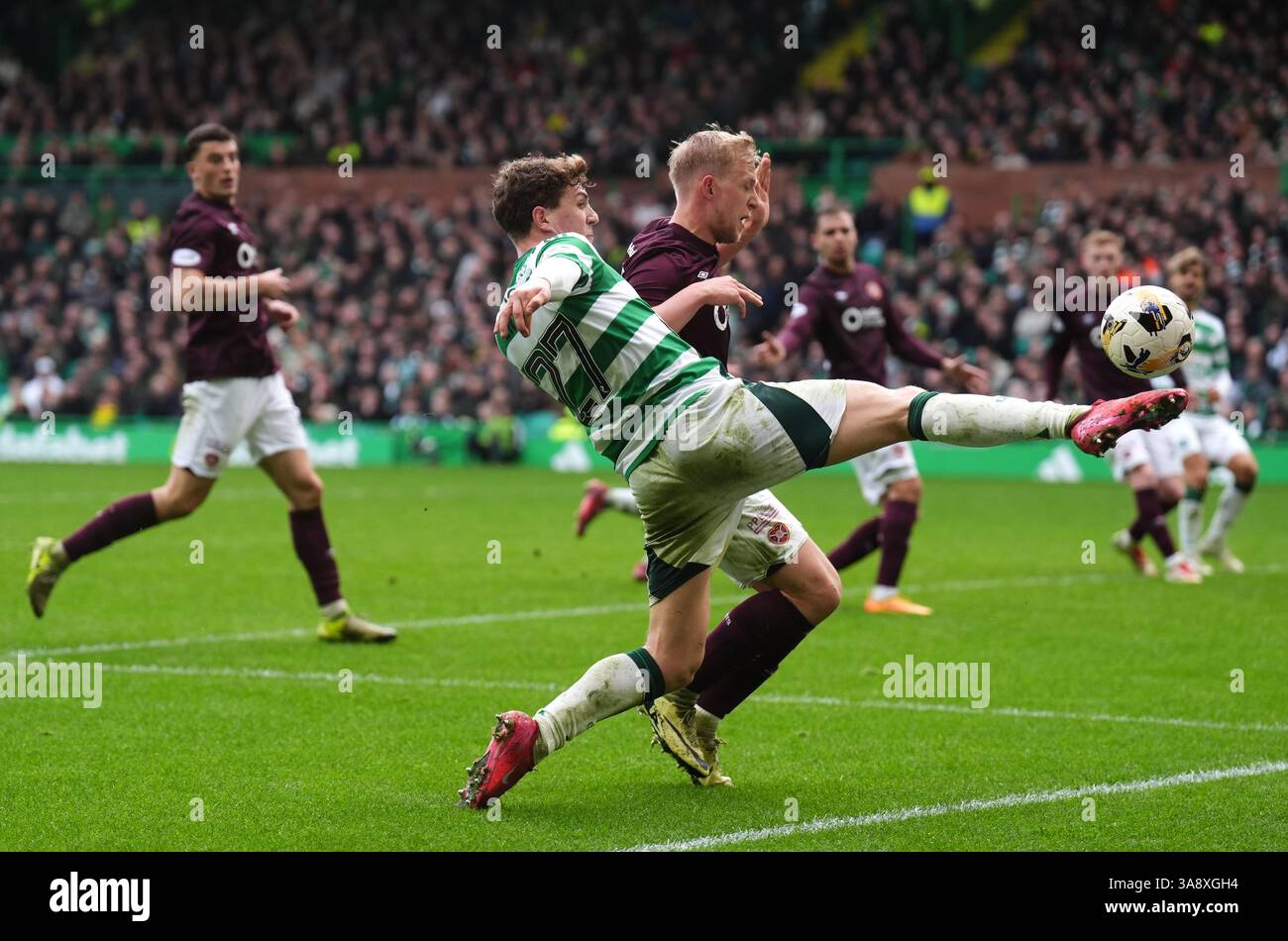 Celtic's Arne Engels and Heart of Midlothian's Harry Milne battle for ...