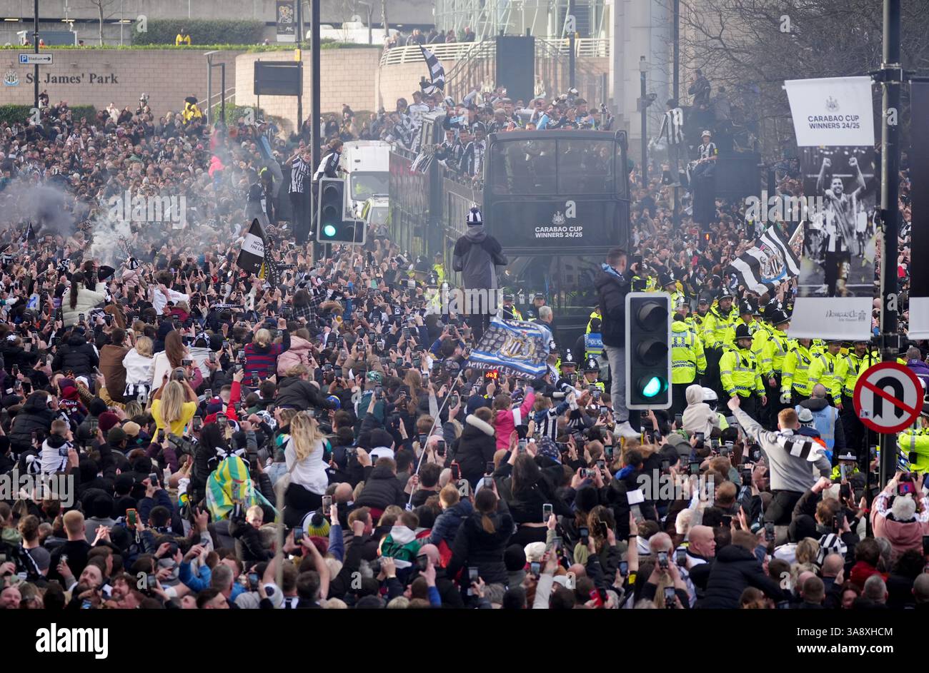 The open top buses carrying the Newcastle United players passes by fans ...