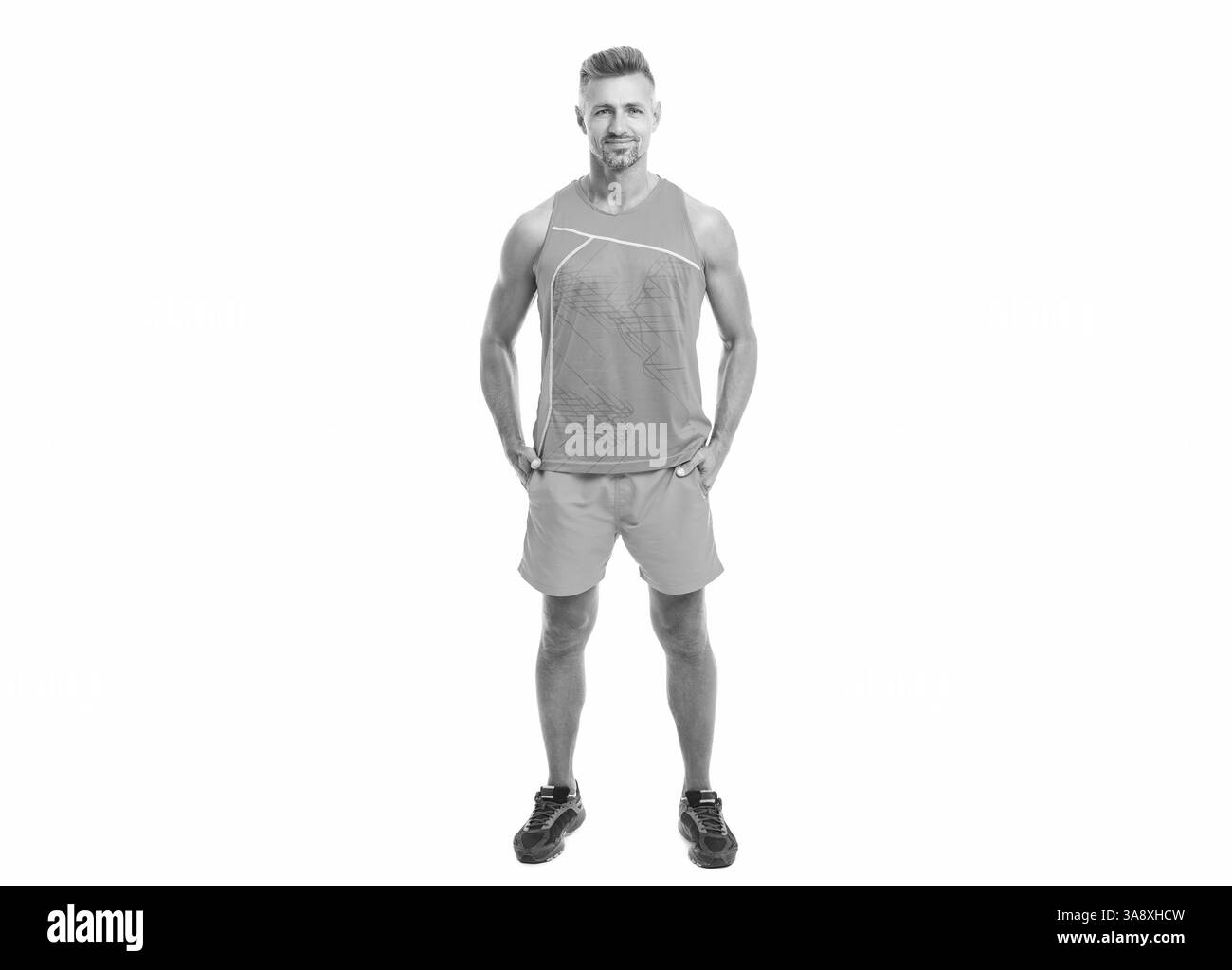 glad athlete wearing sport wear standing alone. The male sport athlete ...