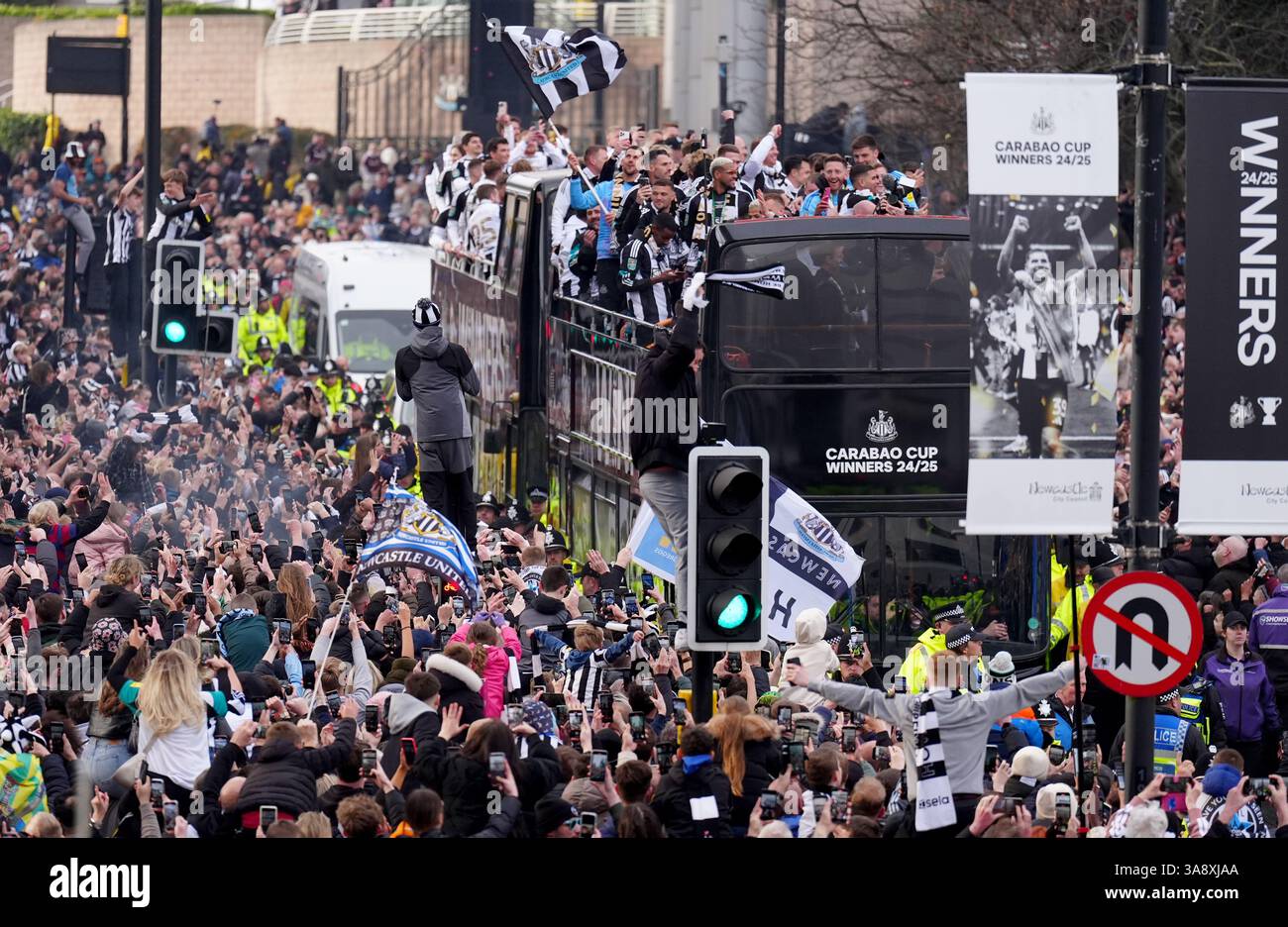 The open top buses carrying the Newcastle United players passes by fans ...