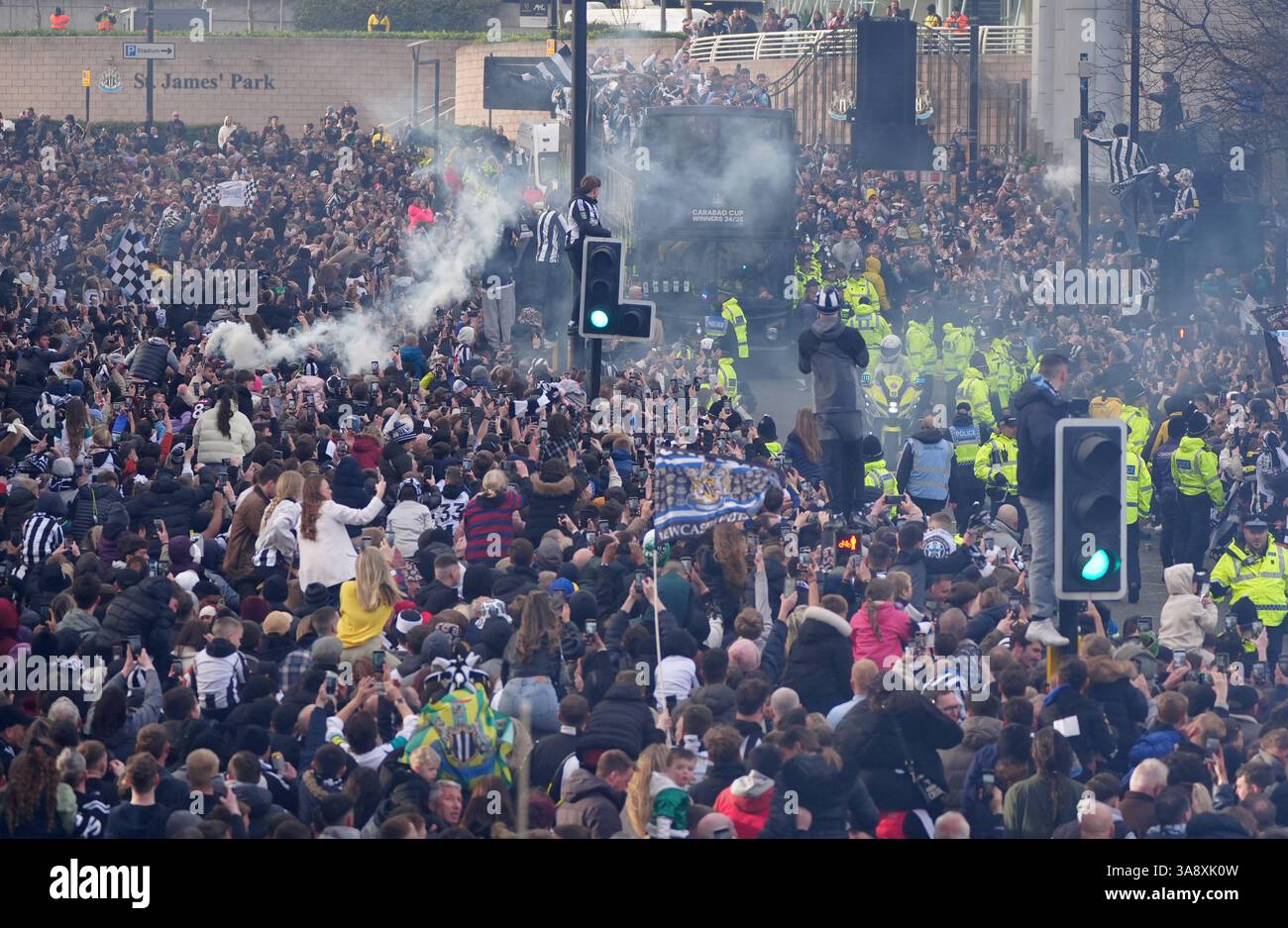 The open top buses carrying the Newcastle United players passes by fans ...