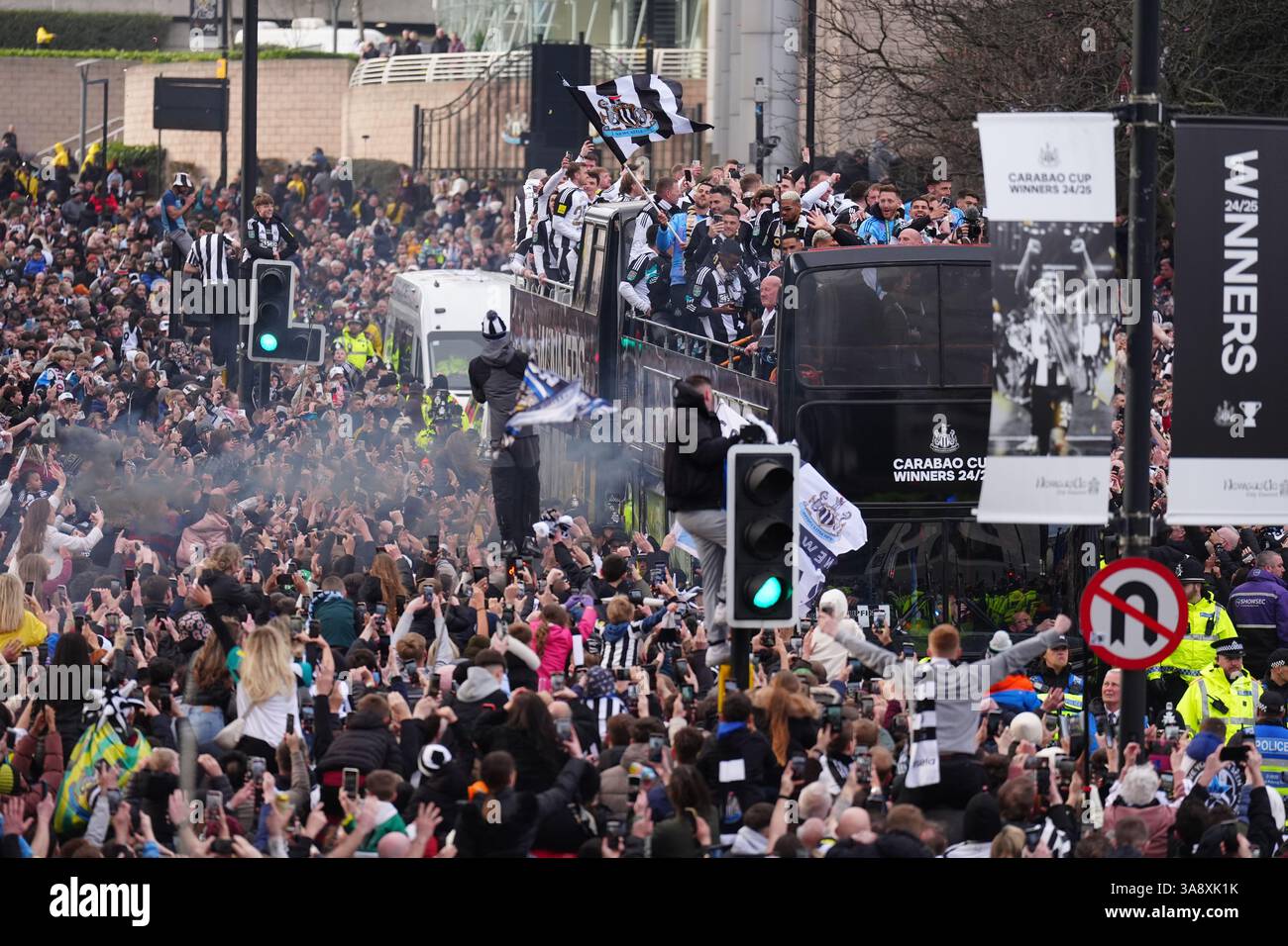 The open top buses carrying the Newcastle United players passes by fans ...