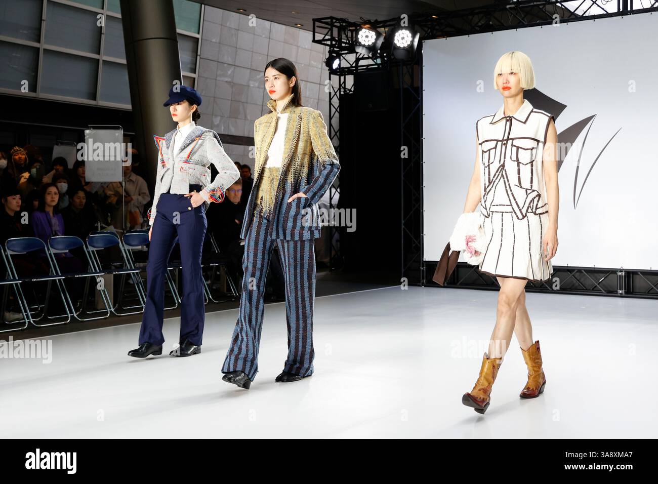 Tokyo, Japan. 29th Mar, 2025. Models walk down a runway during the ...