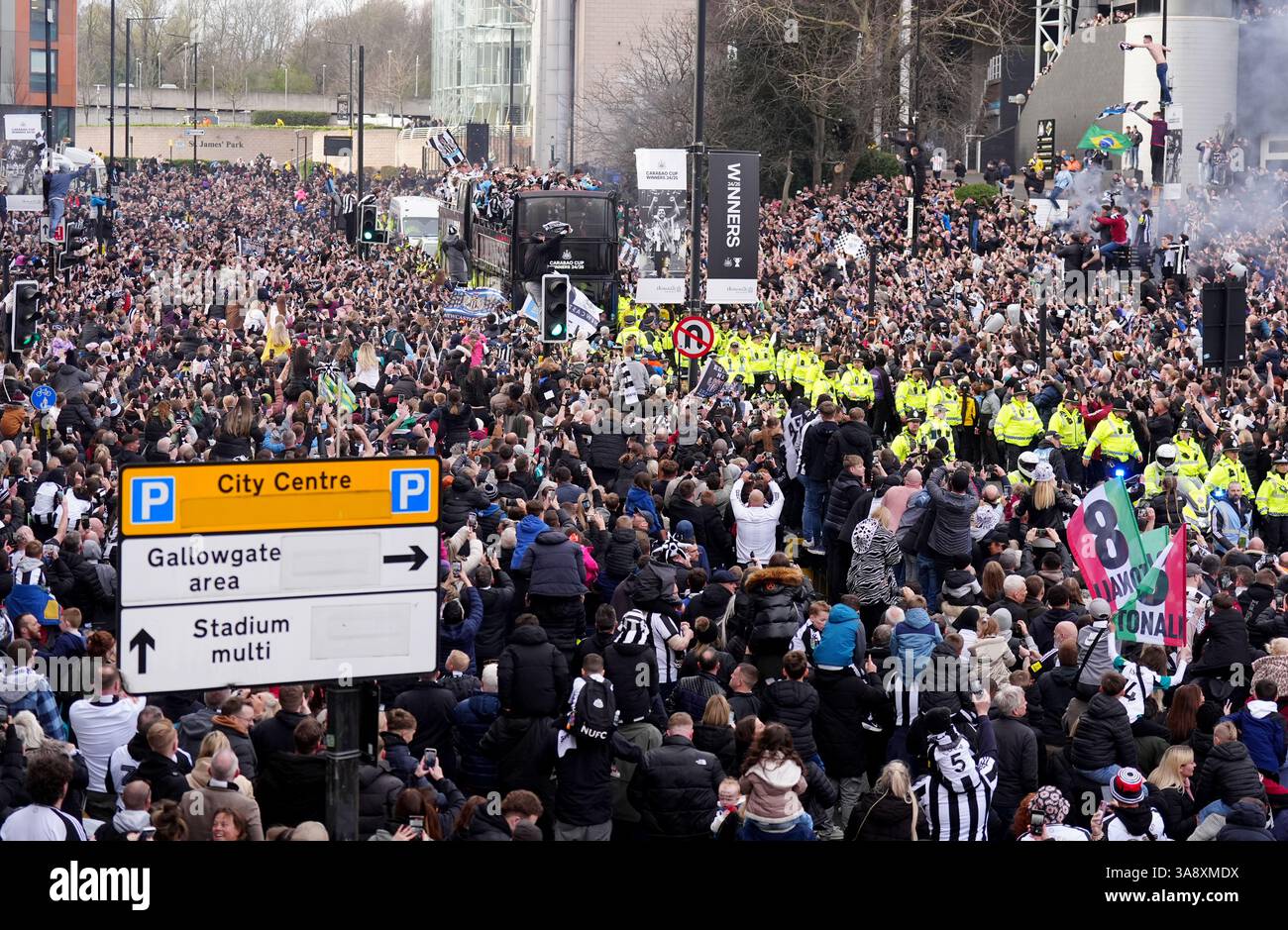 The open top buses carrying the Newcastle United players passes by fans ...