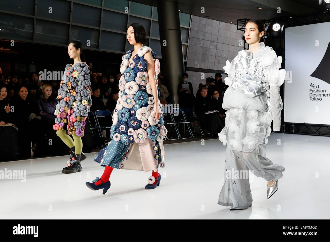 Tokyo, Japan. 29th Mar, 2025. Models walk down a runway during the ...