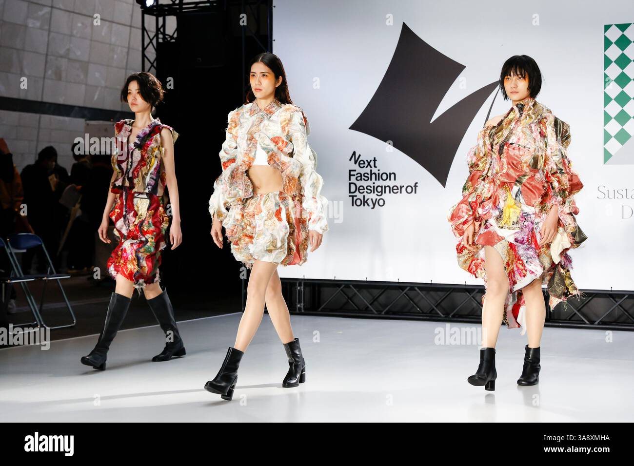 Tokyo, Japan. 29th Mar, 2025. Models walk down a runway during the ...