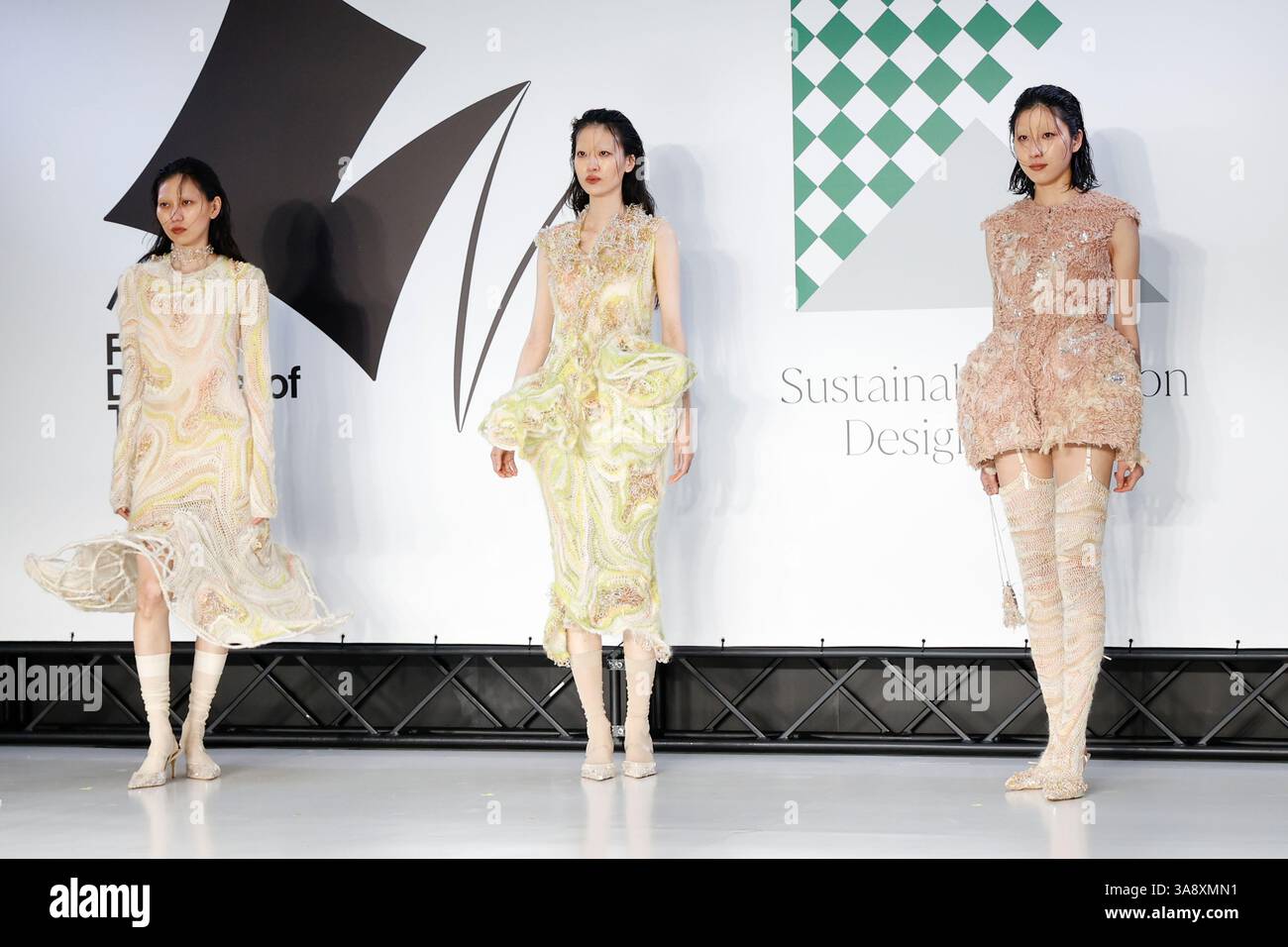 Tokyo, Japan. 29th Mar, 2025. Models walk down a runway during the ...
