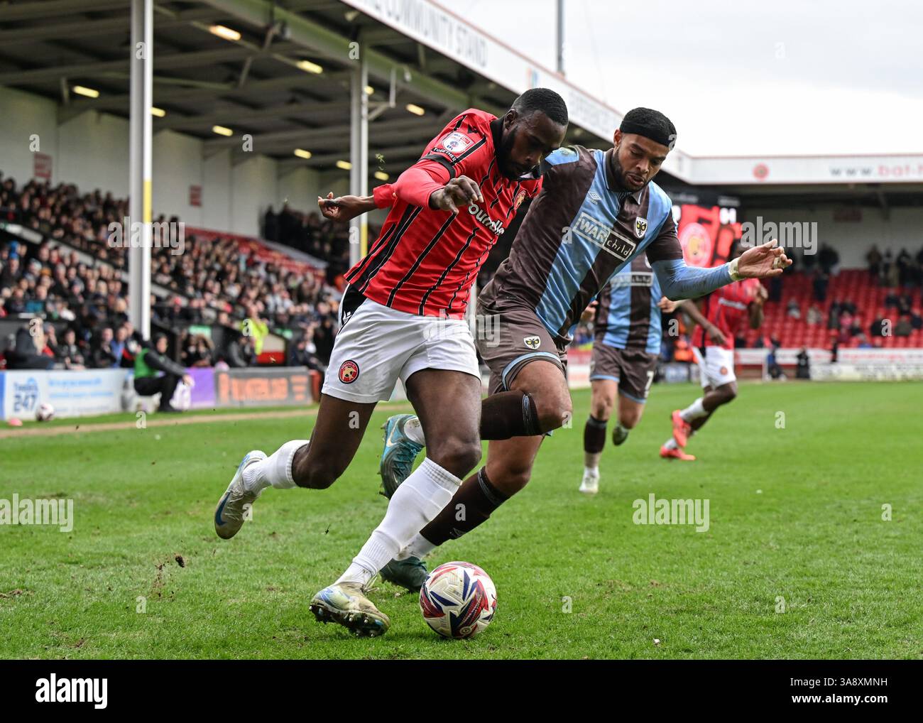 Walsall's Levi Amantchi breaks past AFC Wimbledon's Ryan Johnson during ...