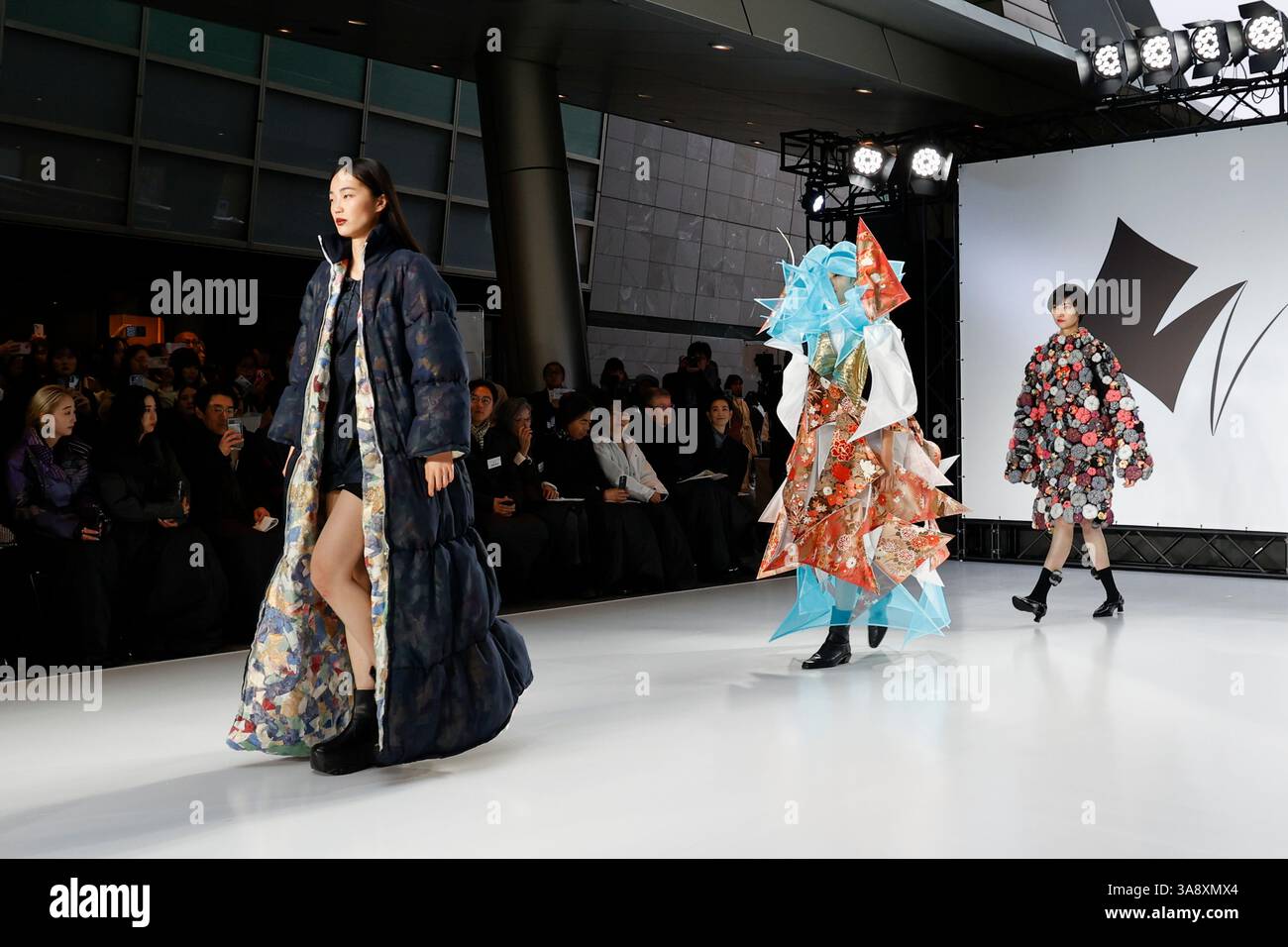 Tokyo, Japan. 29th Mar, 2025. Models walk down a runway during the ...