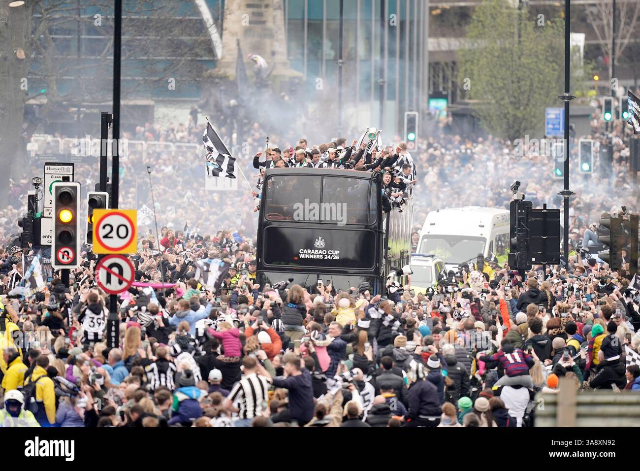 Newcastle United fans watch on as the players pass by aboard an open ...