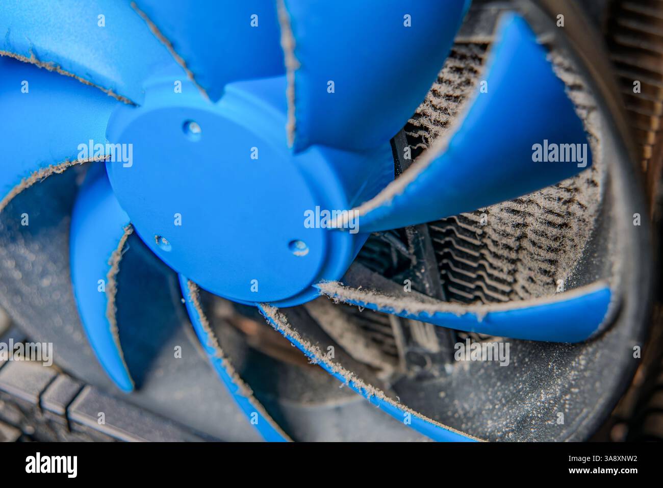 Extreme close-up of a dusty CPU cooler and heatsink clogged with thick ...