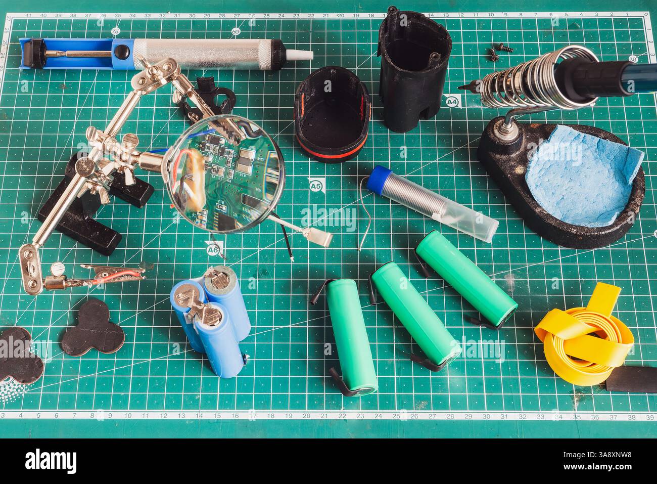 Close-up scene of repairing an old power tool battery on a soldering ...