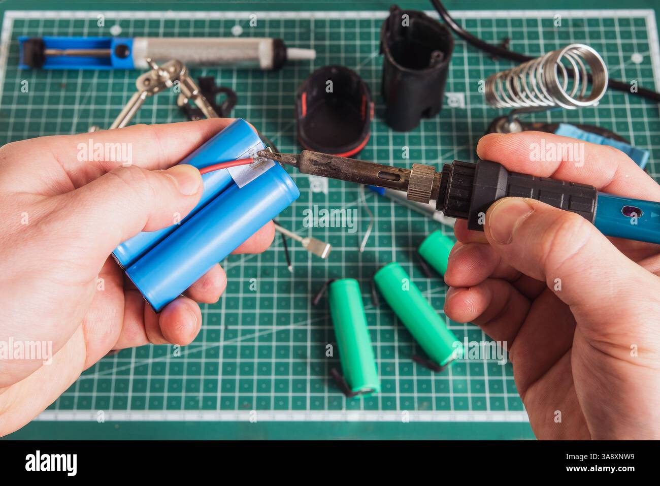 Close-up scene of repairing an old power tool battery on a soldering ...