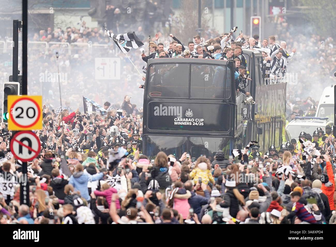 Newcastle United fans watch on as the players pass by aboard an open ...