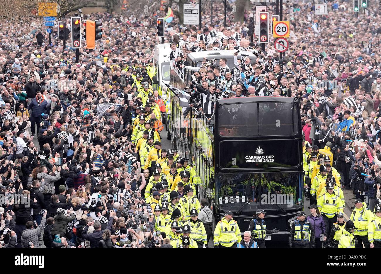 Newcastle United fans watch on as the players pass by aboard an open ...