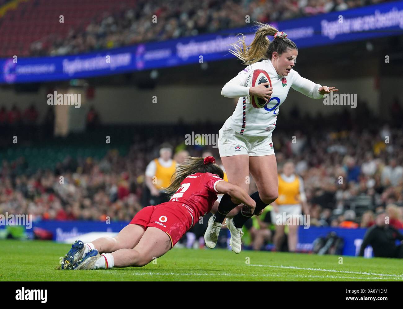 England’s Jess Breach (right) is tackled by Wales’ Kayleigh Powell ...