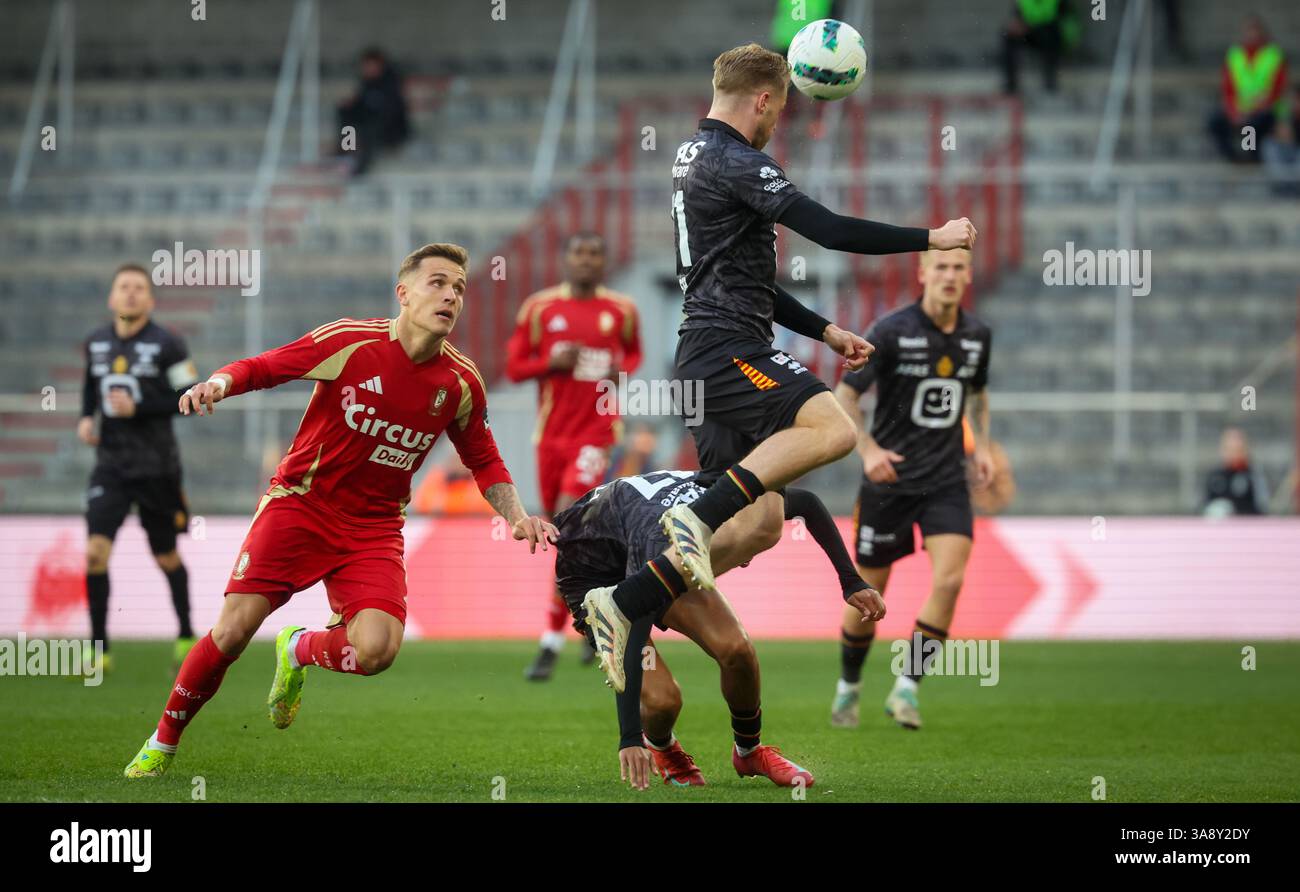 Standard's Dennis Ayensa and Mechelen's Stephen Welsh fight for the ...