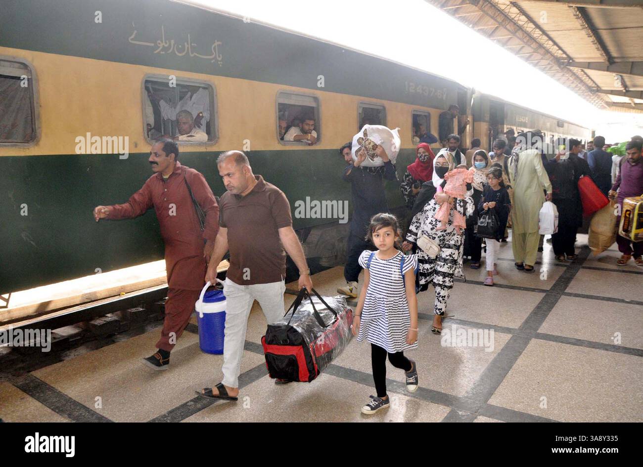A large number of people gather for boarding on special Eid train as they are going to their ...