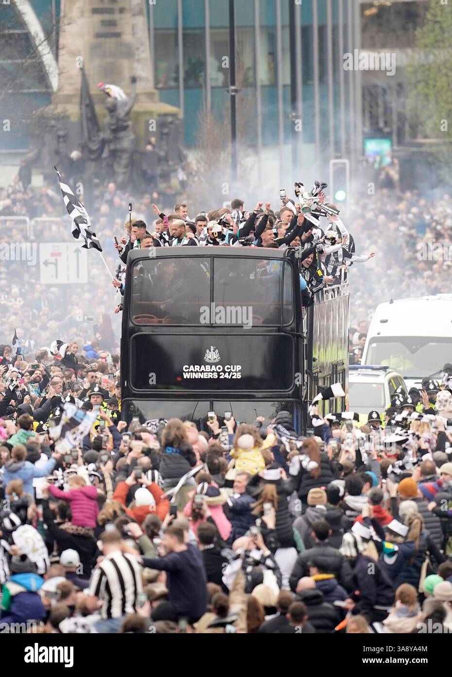 Newcastle United fans watch on as the players pass by aboard an open ...