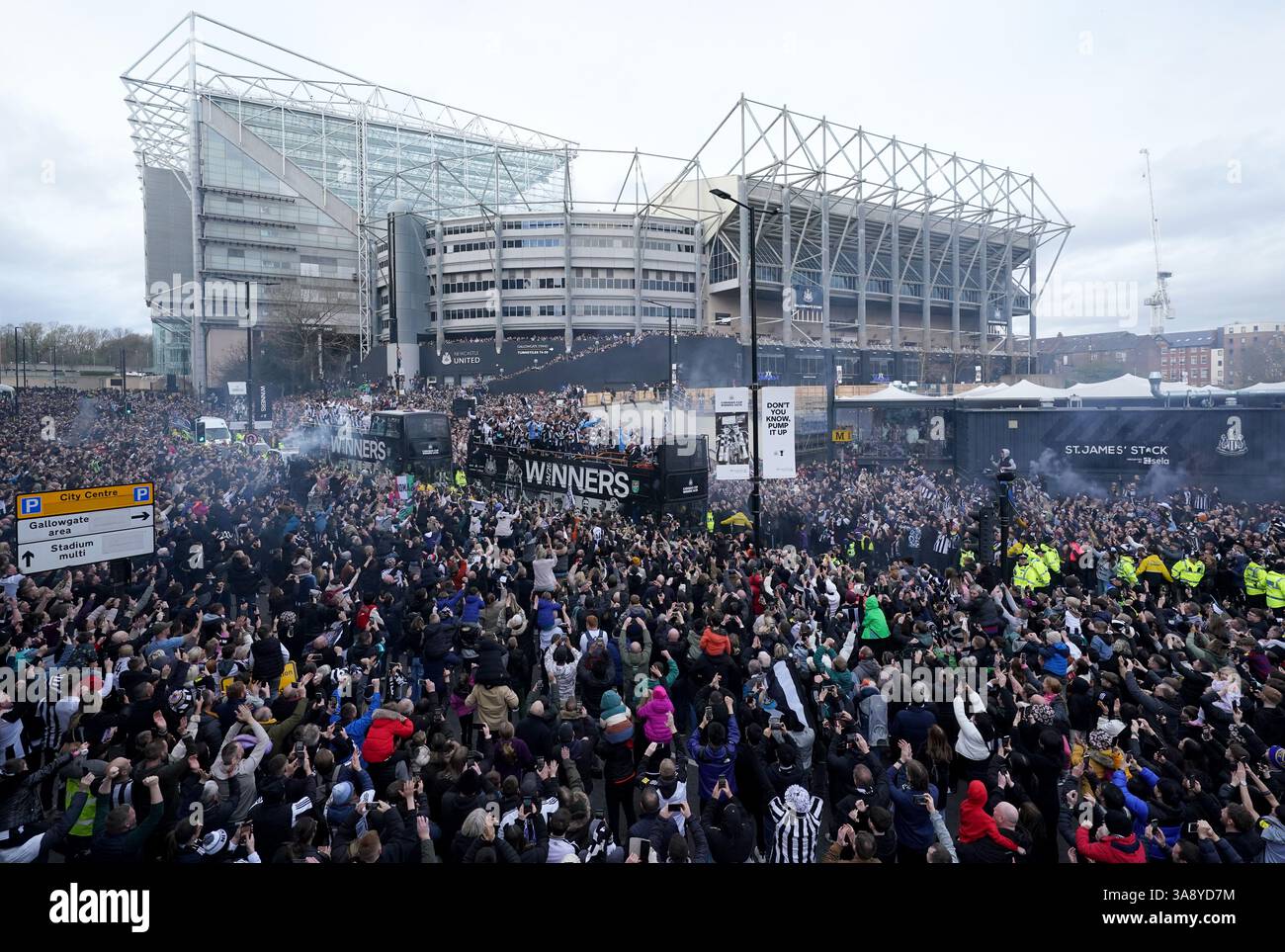 The open top buses carrying the Newcastle United players passes by fans ...