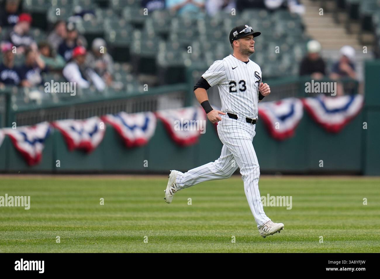 Chicago White Sox left fielder Andrew Benintendi (23) warms up before a ...