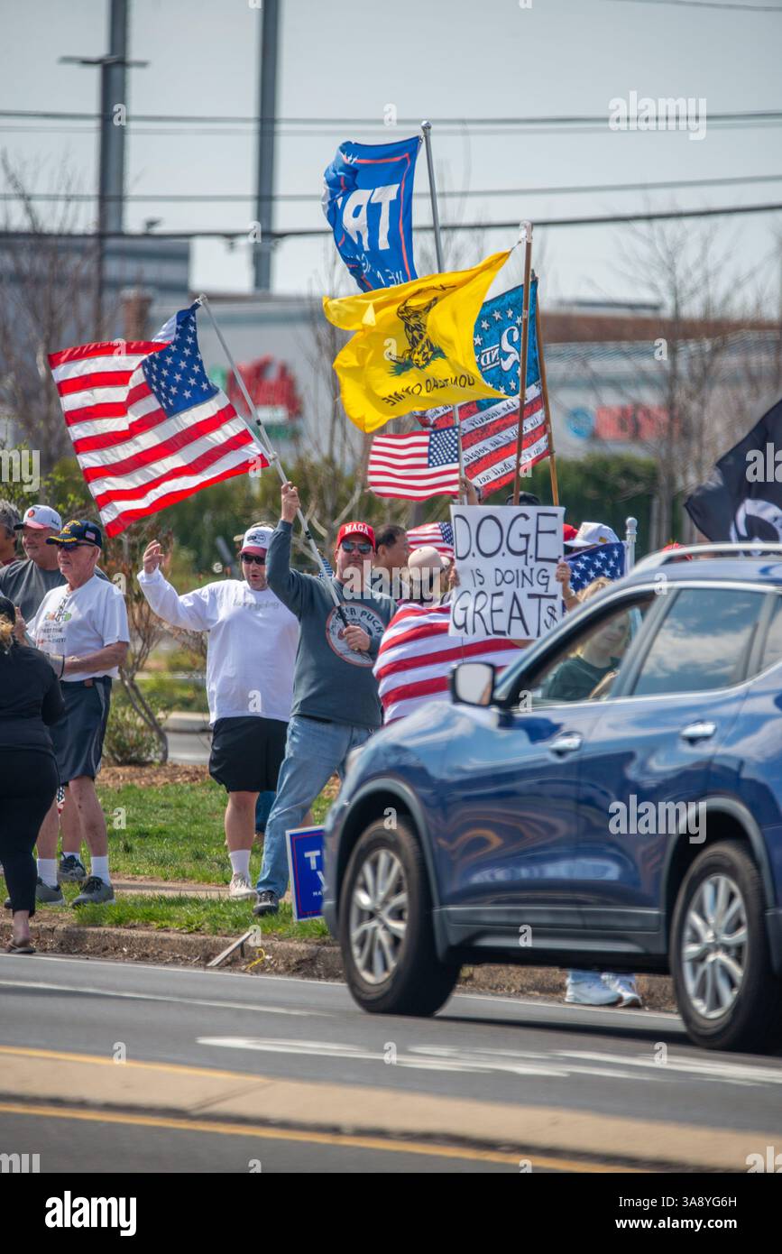 People wave flags during a rally in support of US President Trump, Elon ...