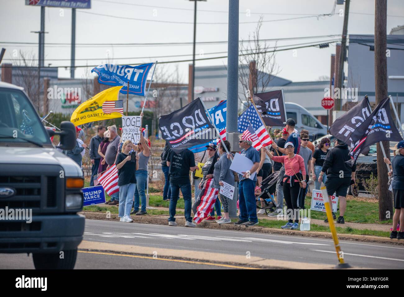 People wave flags during a rally in support of US President Trump, Elon ...